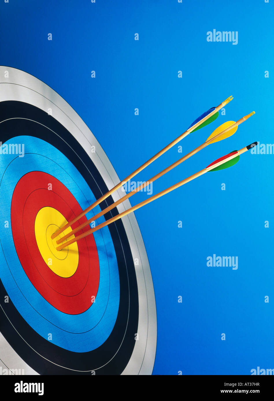 Three arrows in the centre of a target board Stock Photo - Alamy
