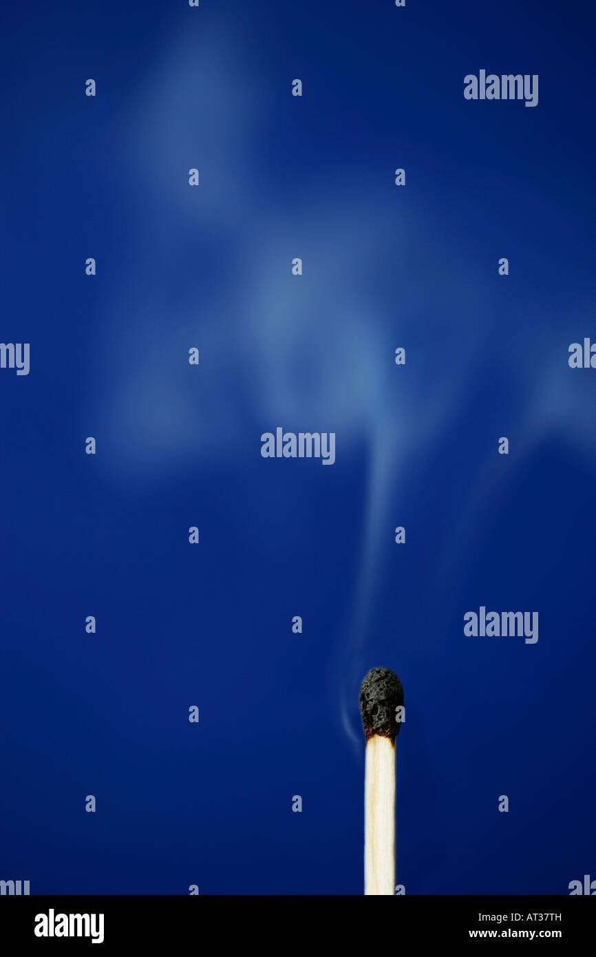 A smoking match, blue background Stock Photo - Alamy