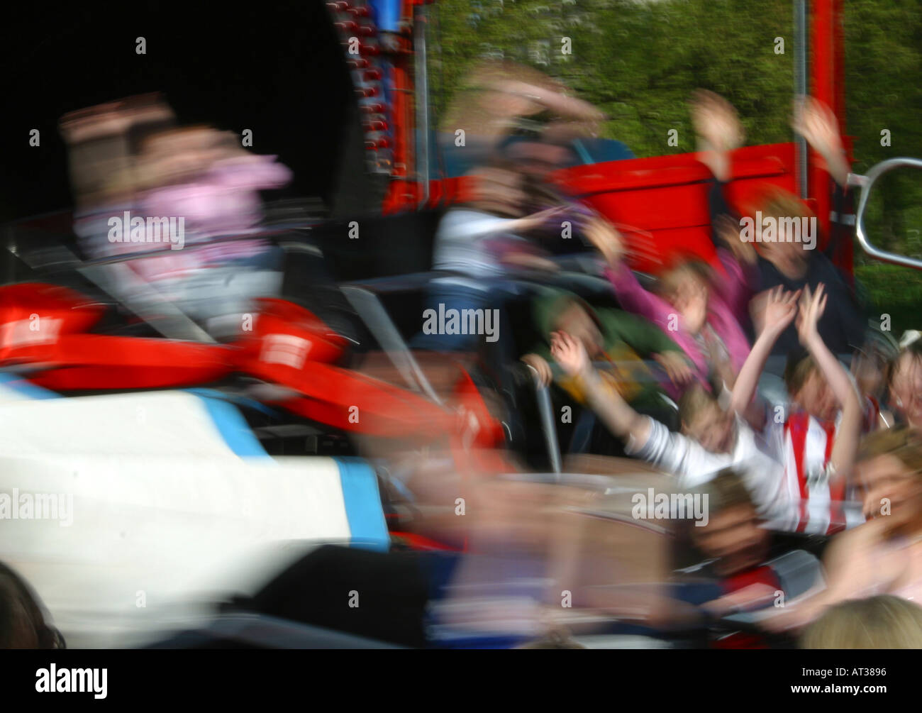 People enjoying high speed funfair ride Stock Photo - Alamy