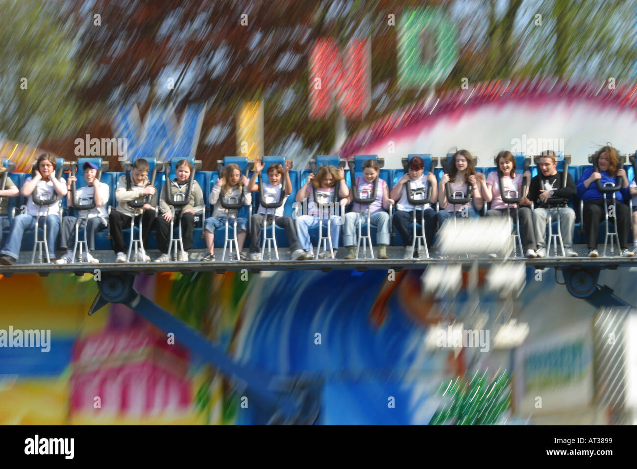 People enjoying high speed funfair ride Stock Photo - Alamy