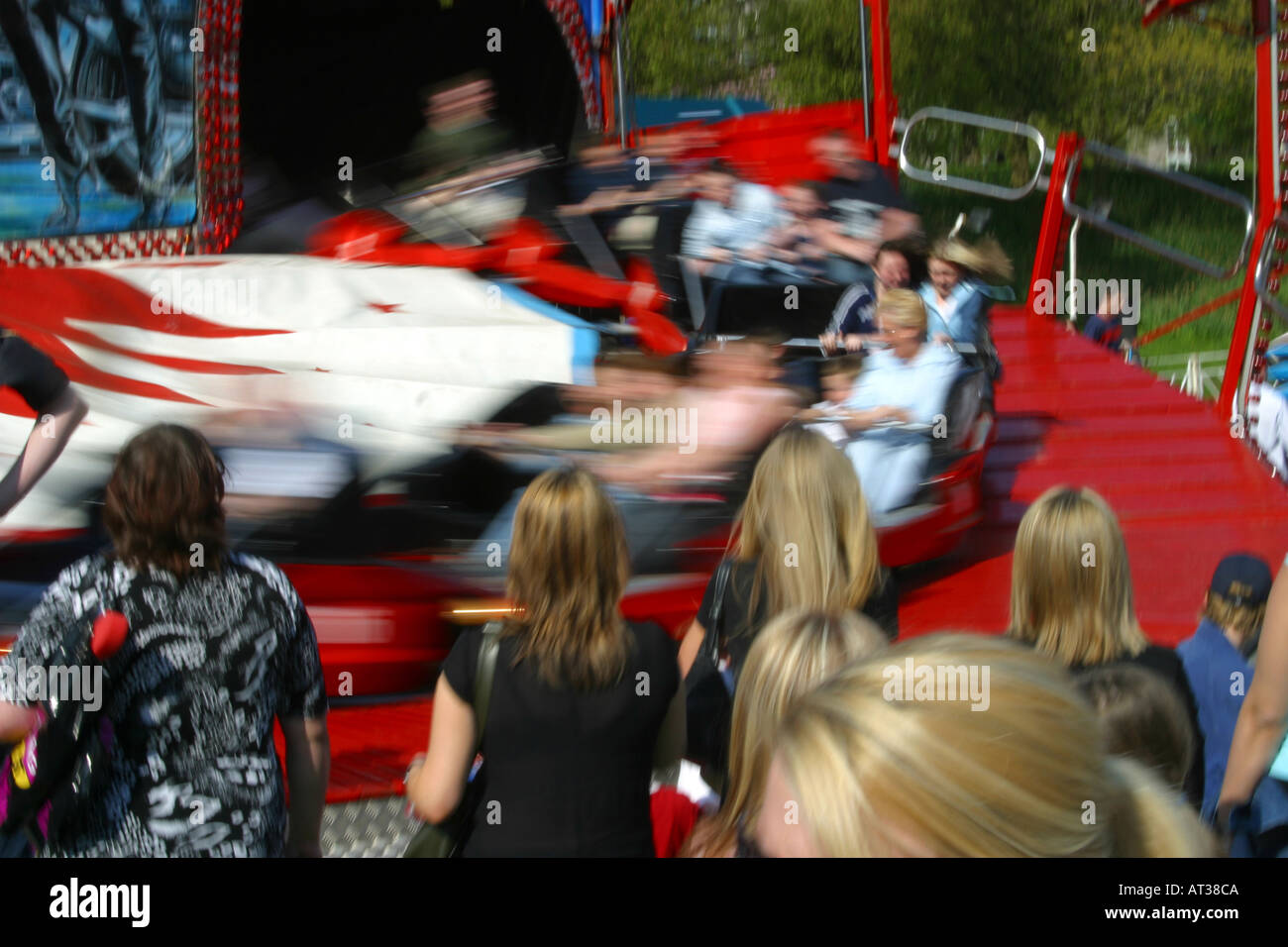 People enjoying high speed funfair ride Stock Photo - Alamy