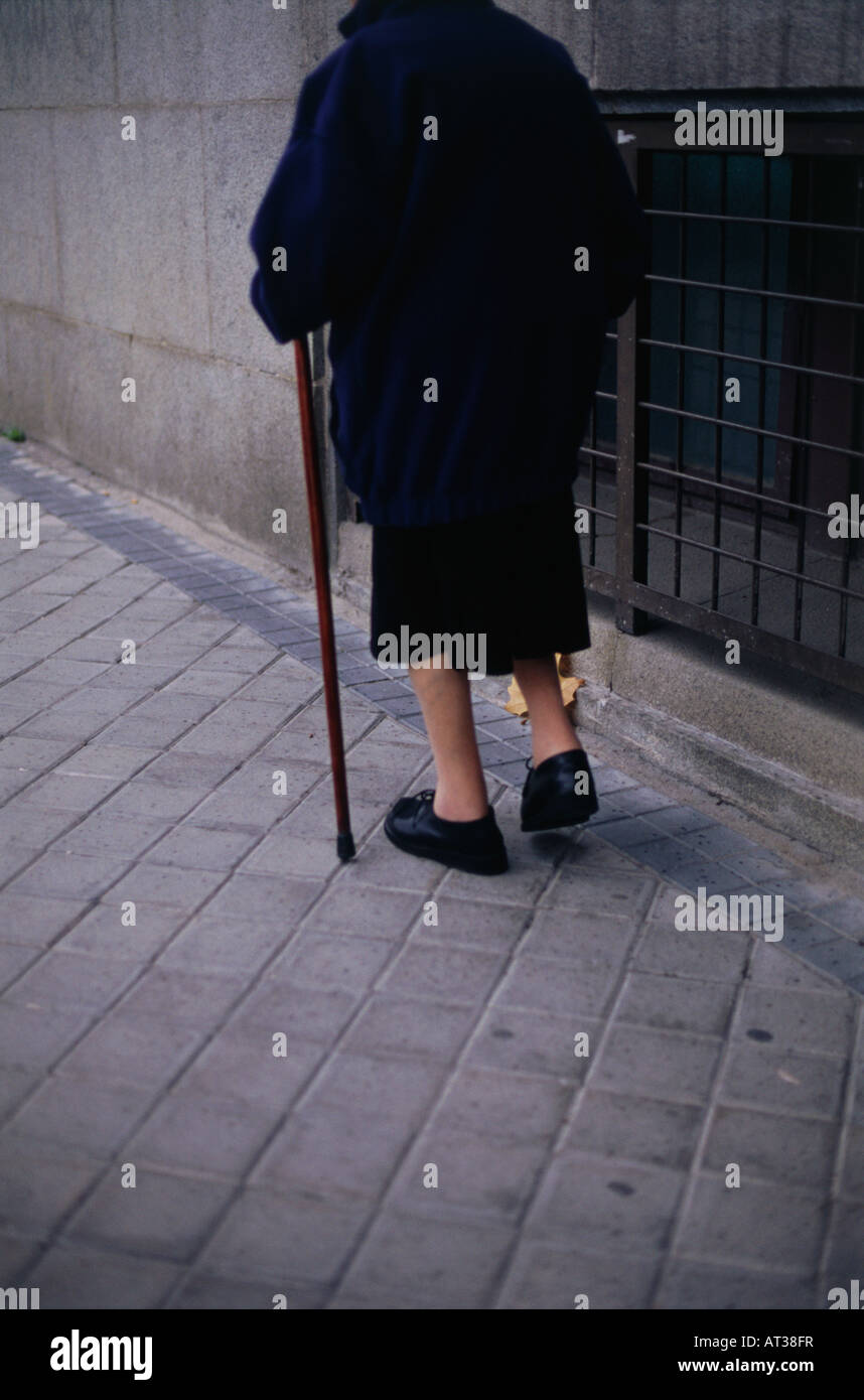 An old woman with a walking stick Stock Photo - Alamy