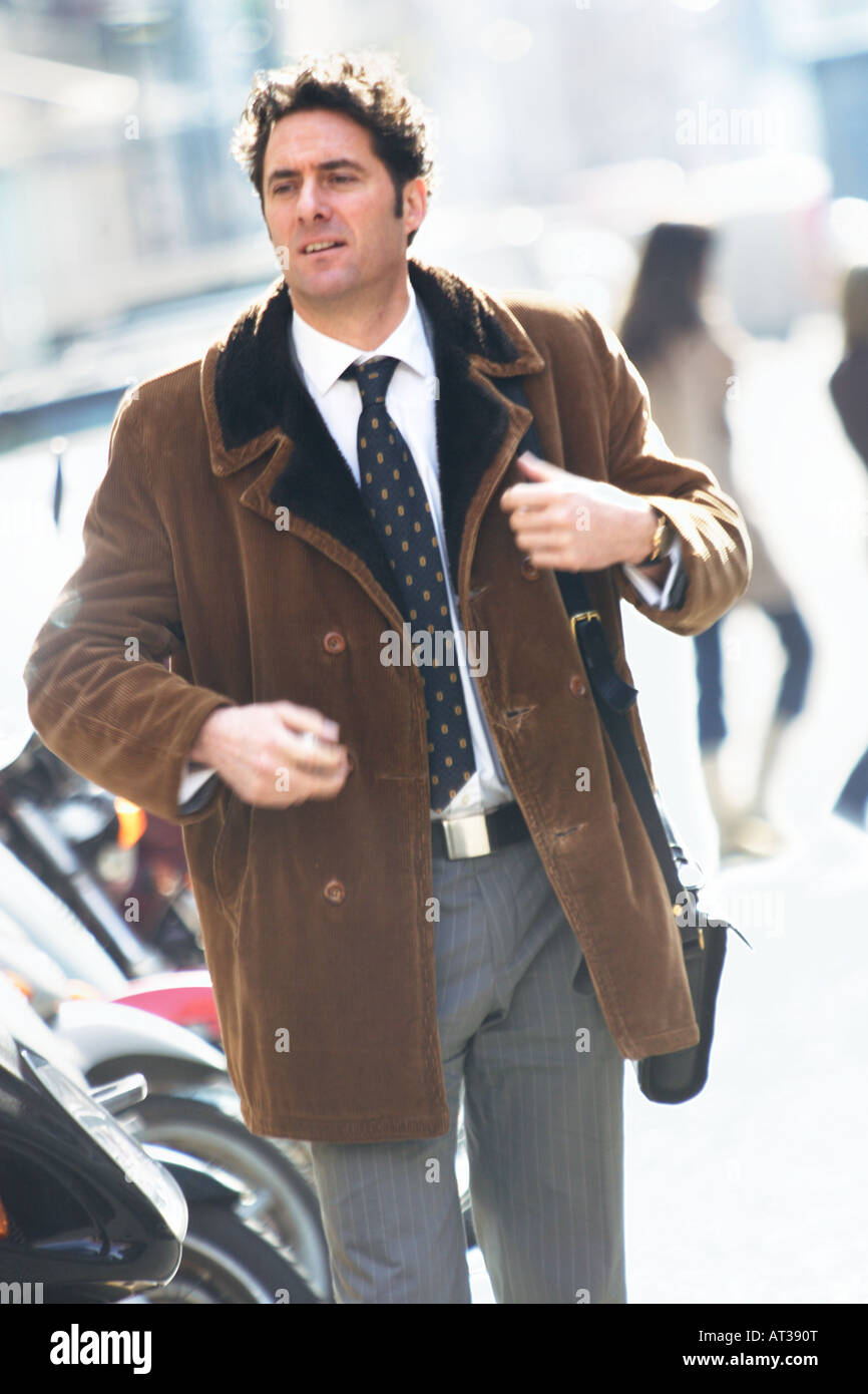 A man walking along a road in a hurry Stock Photo - Alamy