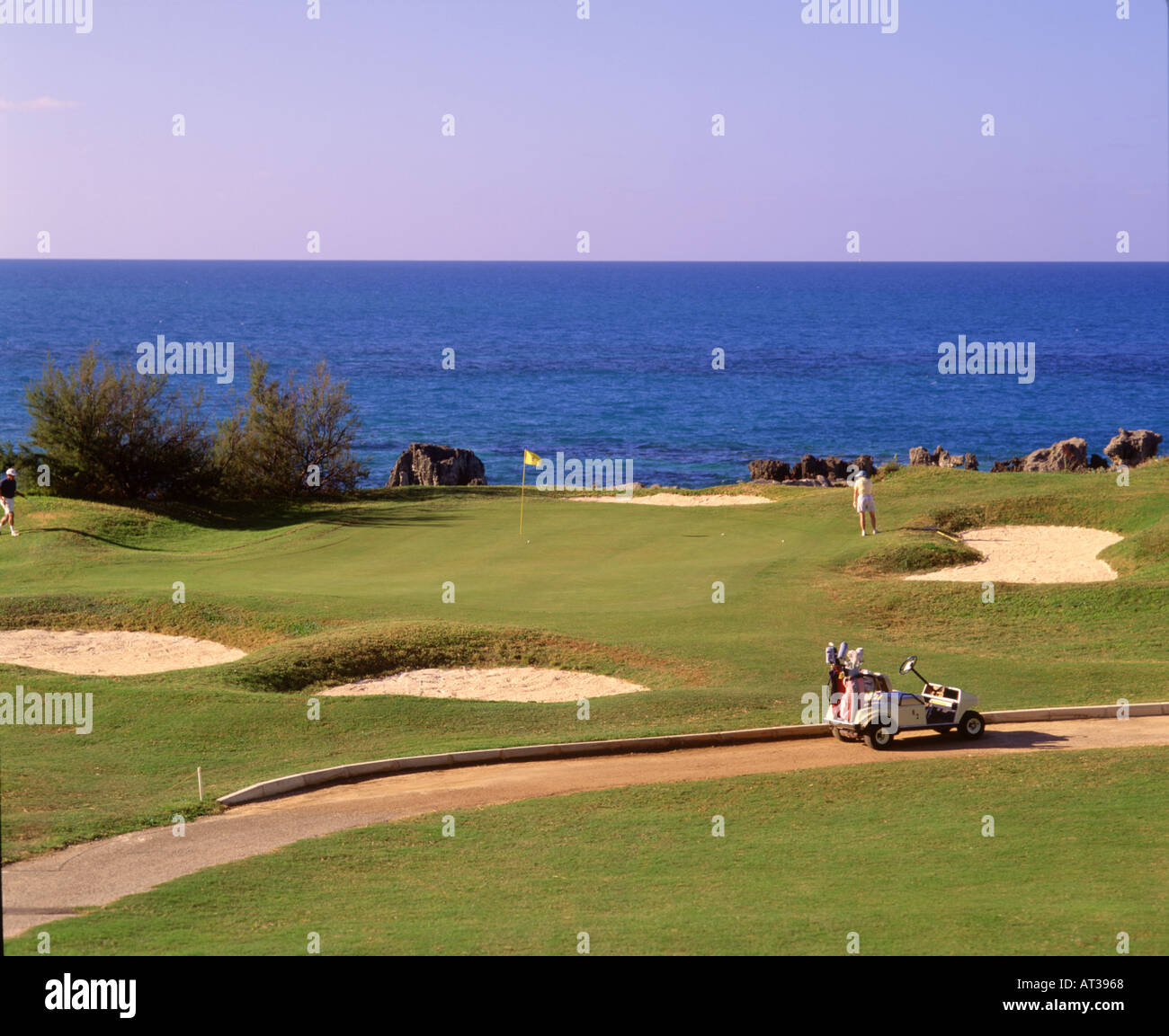 A golf cart sits in front of sand traps on St George's golf course ...