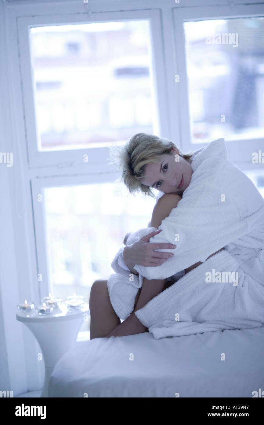 Woman hugging knees bed hi-res stock photography and images - Alamy