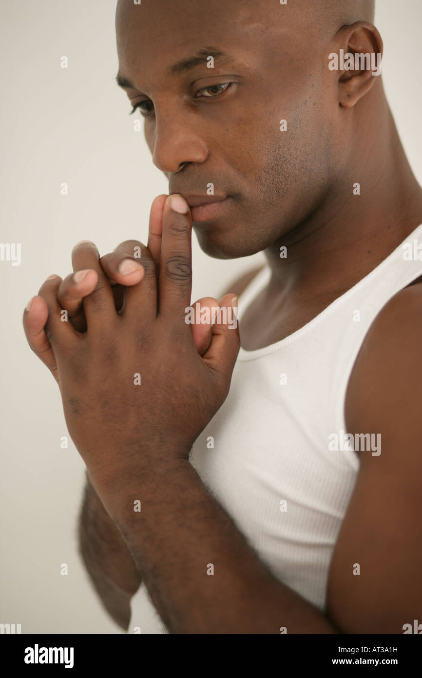 A portrait of a black male in his thirties, fingers touching lips Stock ...