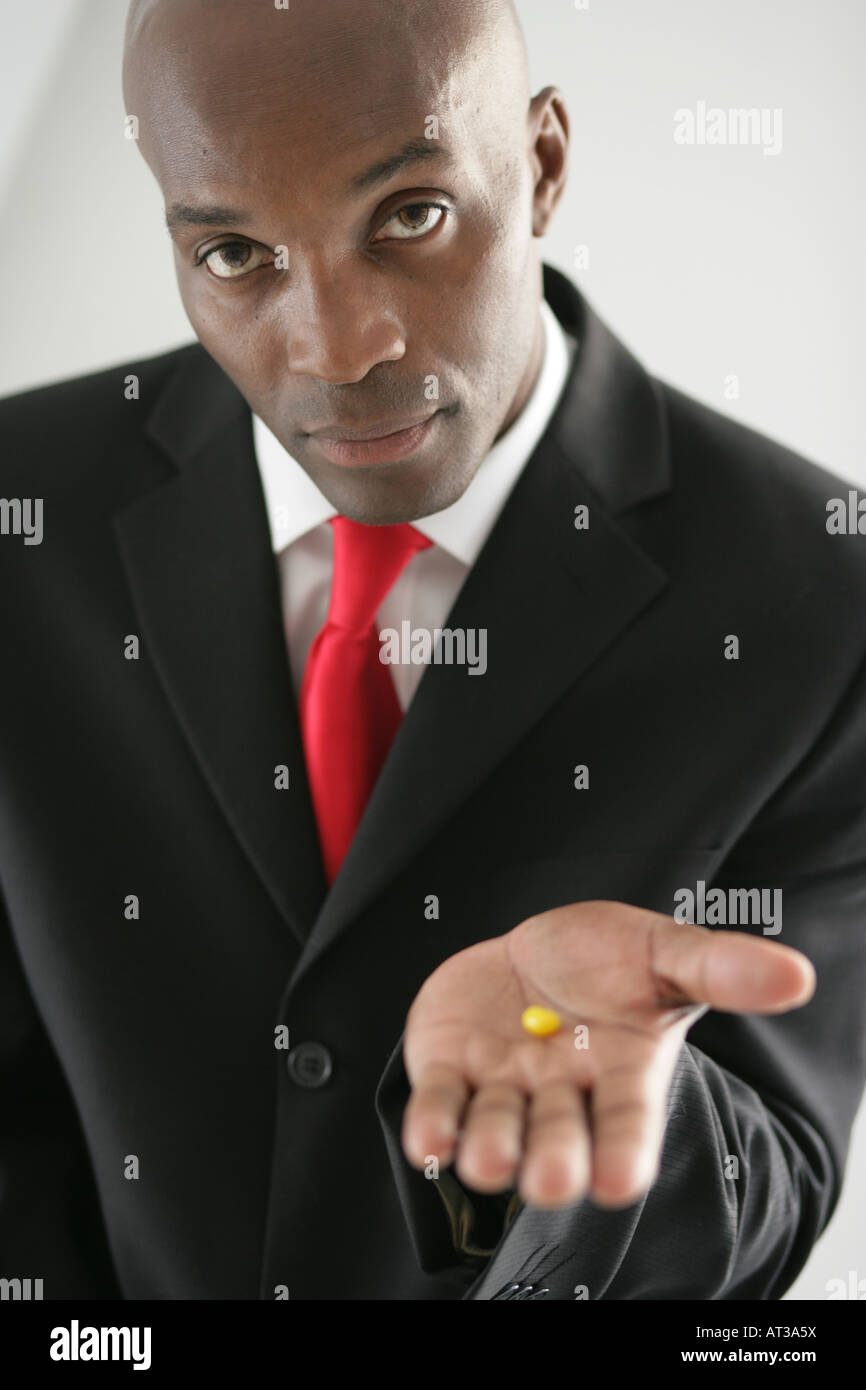 A business man with a jelly bean in his hand Stock Photo - Alamy