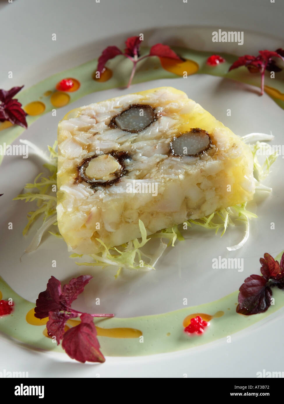 Beautifully presented haute cuisine fish course on a simple white plate ...