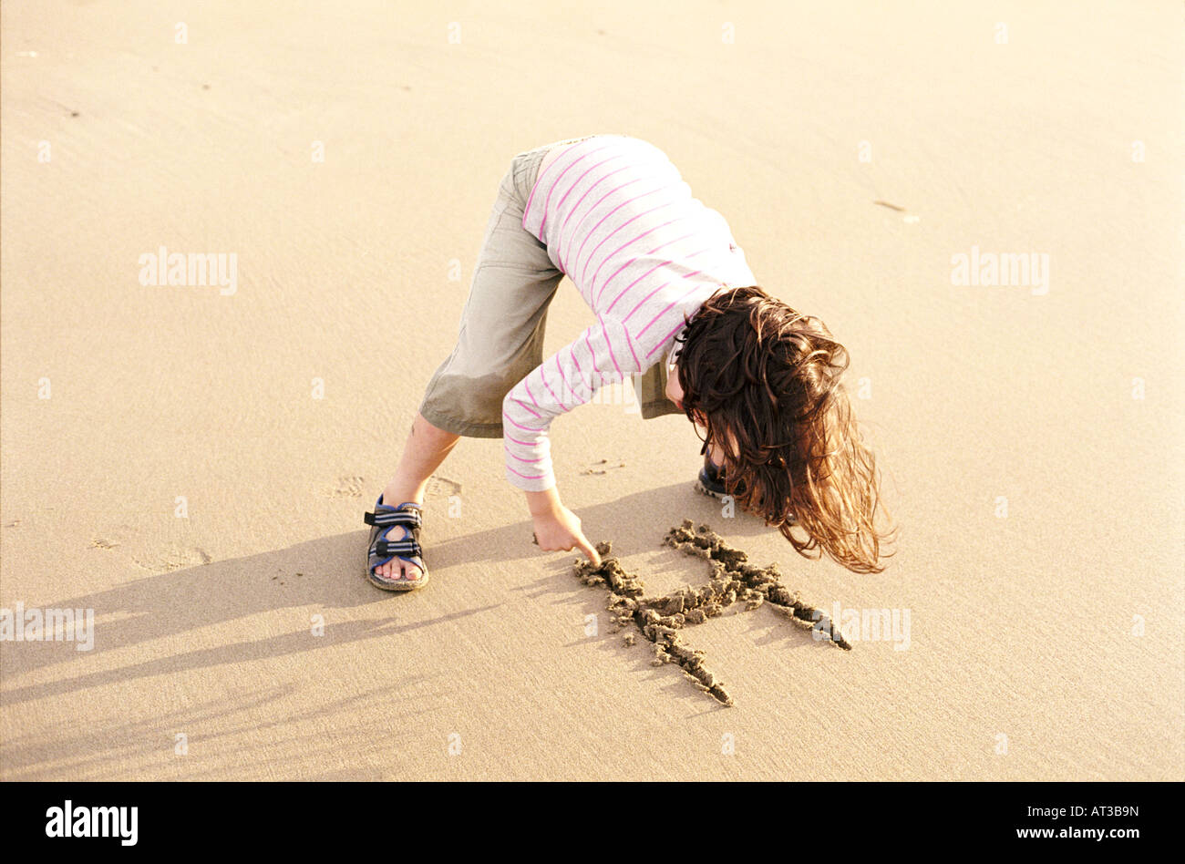 Child writing sand hi-res stock photography and images - Alamy