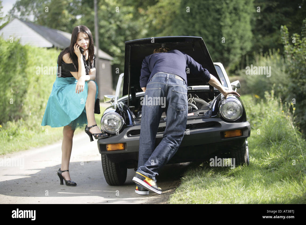 Young couple fixing car hi-res stock photography and images - Alamy