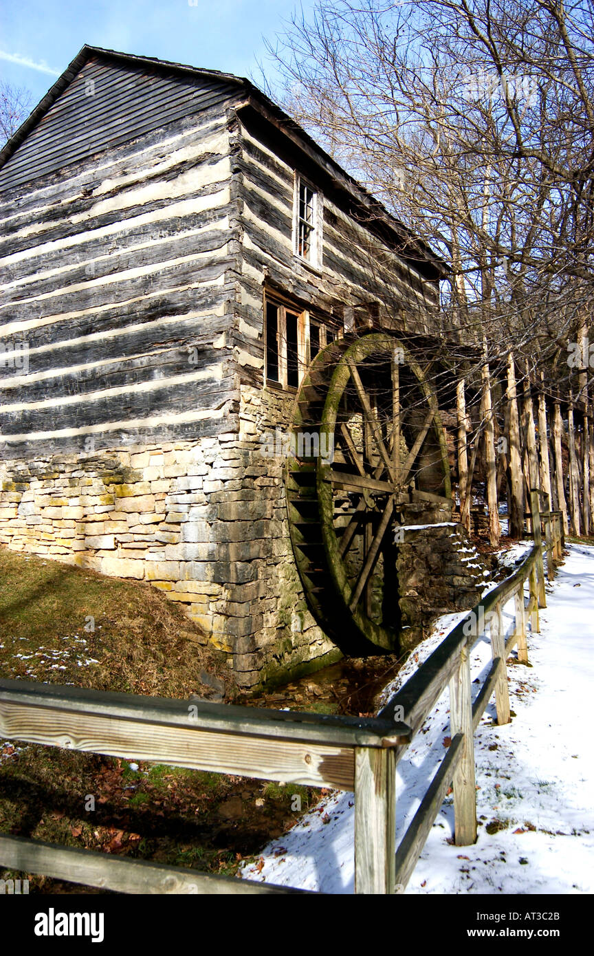 Old grist mill with water wheel in winter with snow at Squire Boone ...