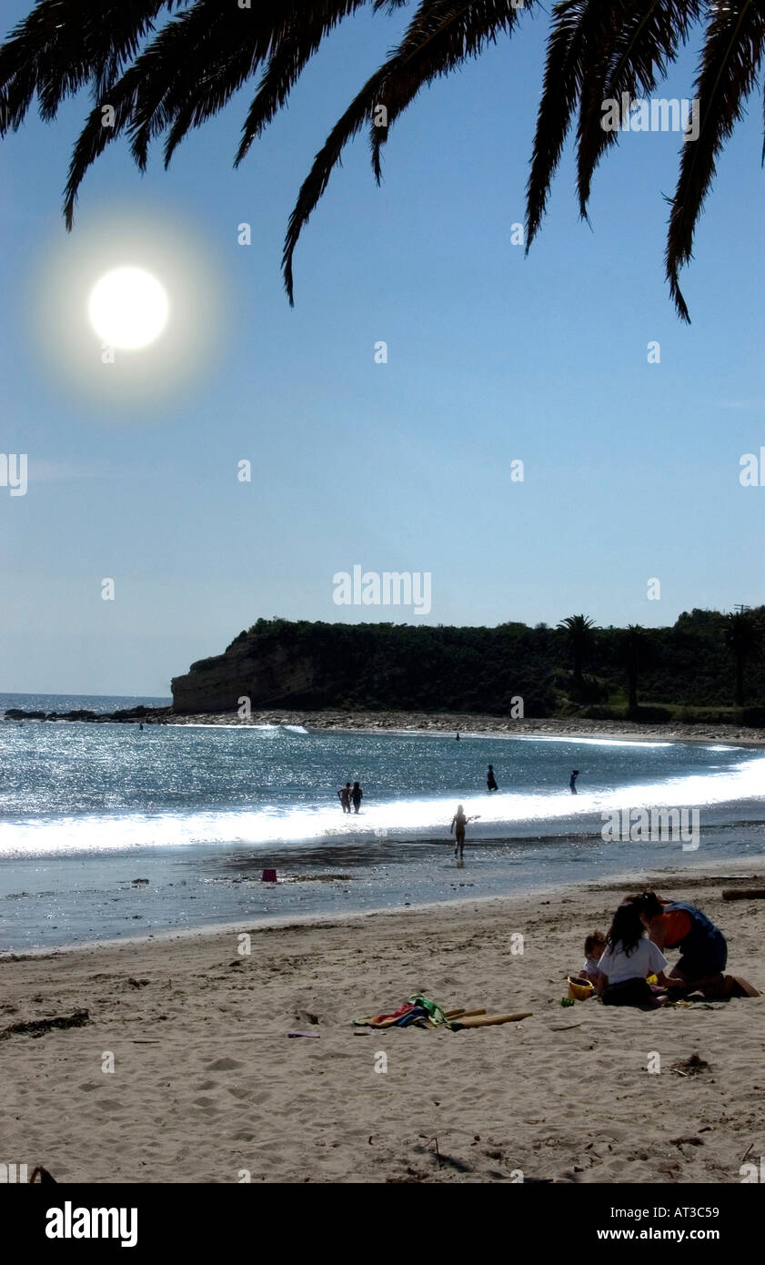 Bright round sun over California beach with waves surf and people Stock ...