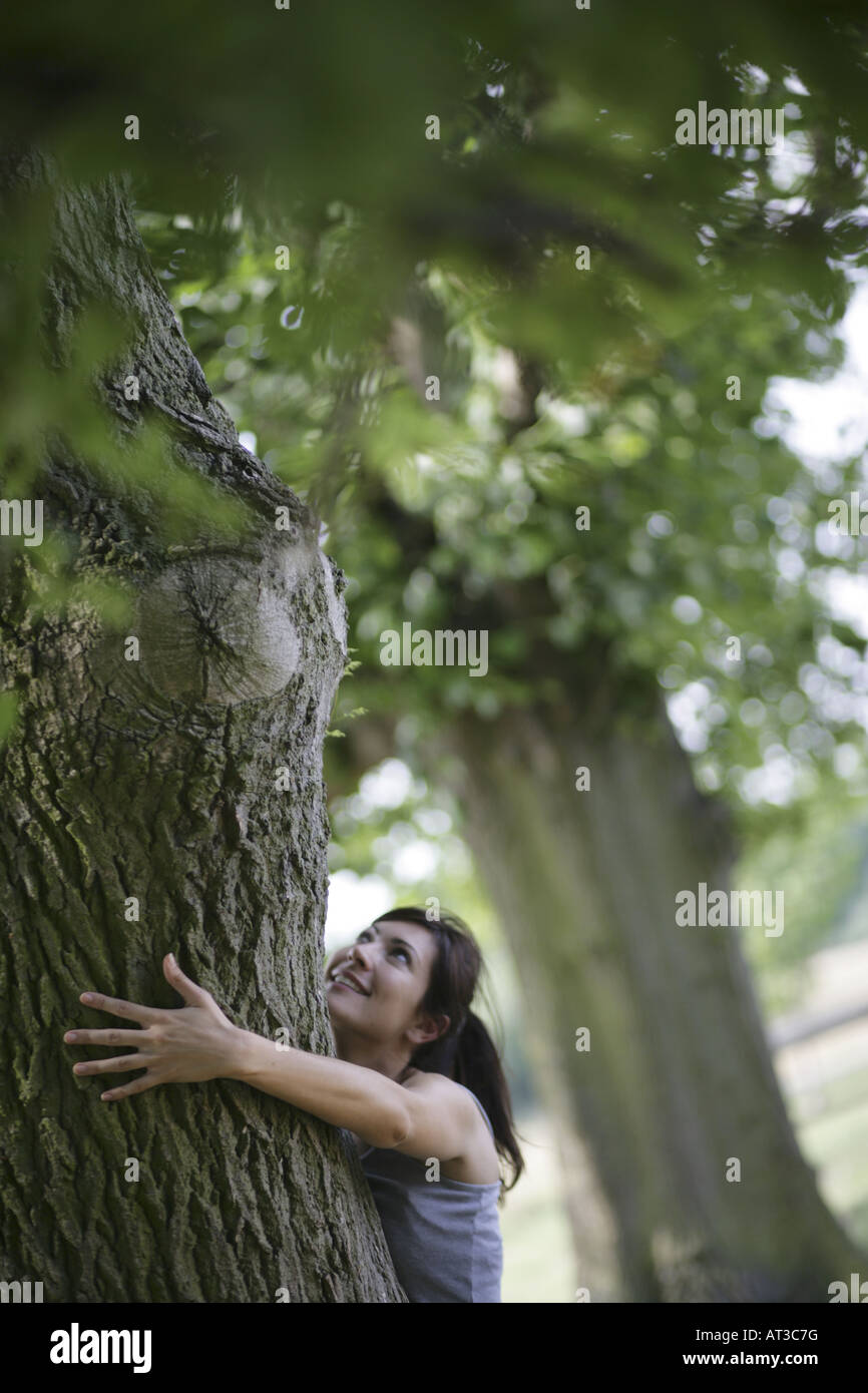 A young woman hugging a tree Stock Photo - Alamy