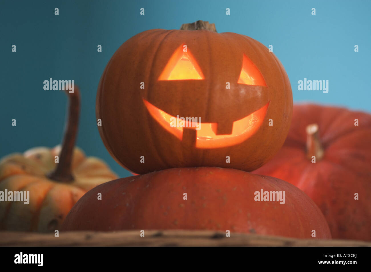 A carved pumpkin on top of a selection of pumpkins Stock Photo - Alamy