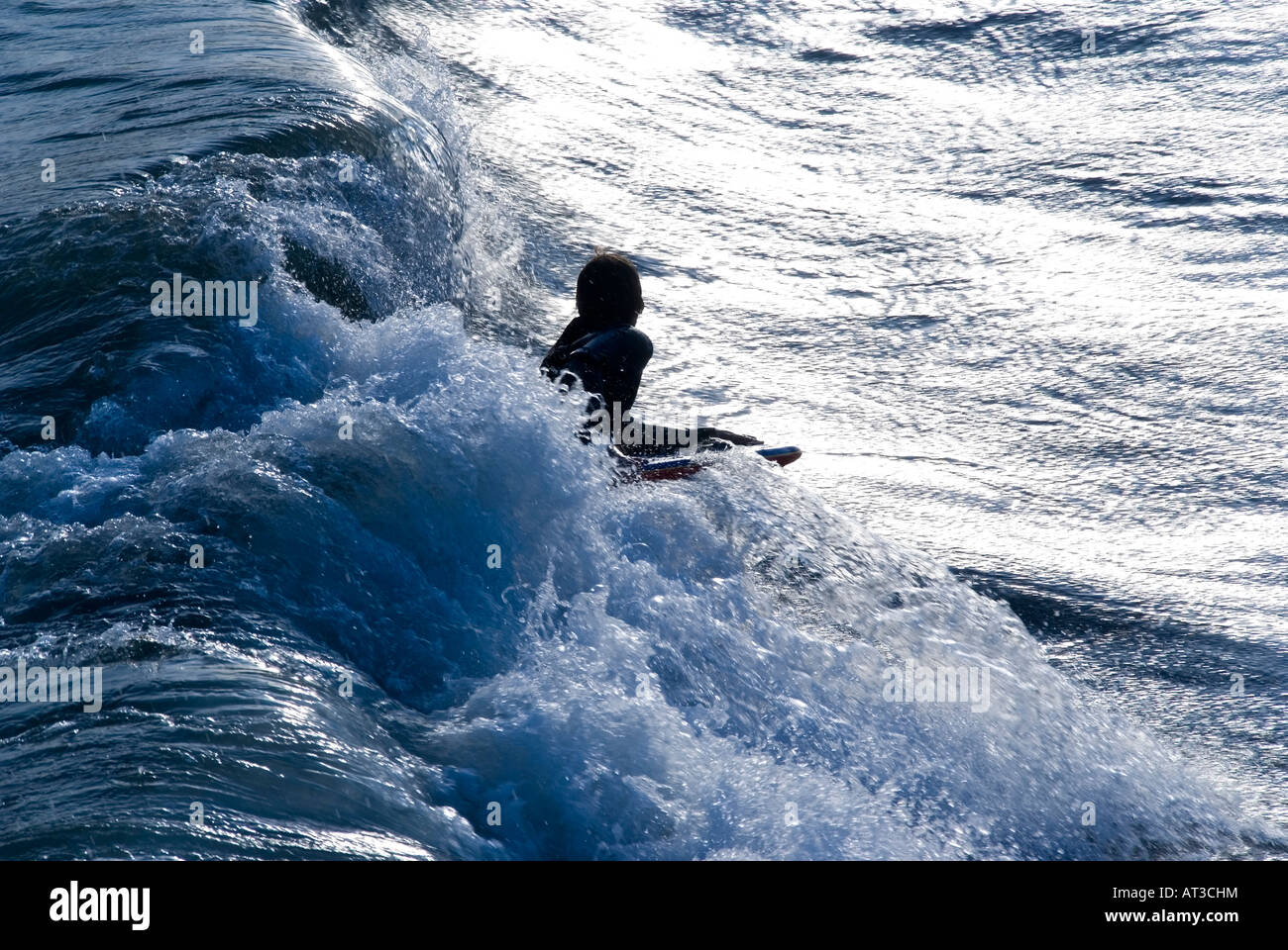 a surfer riding a wave Stock Photo - Alamy
