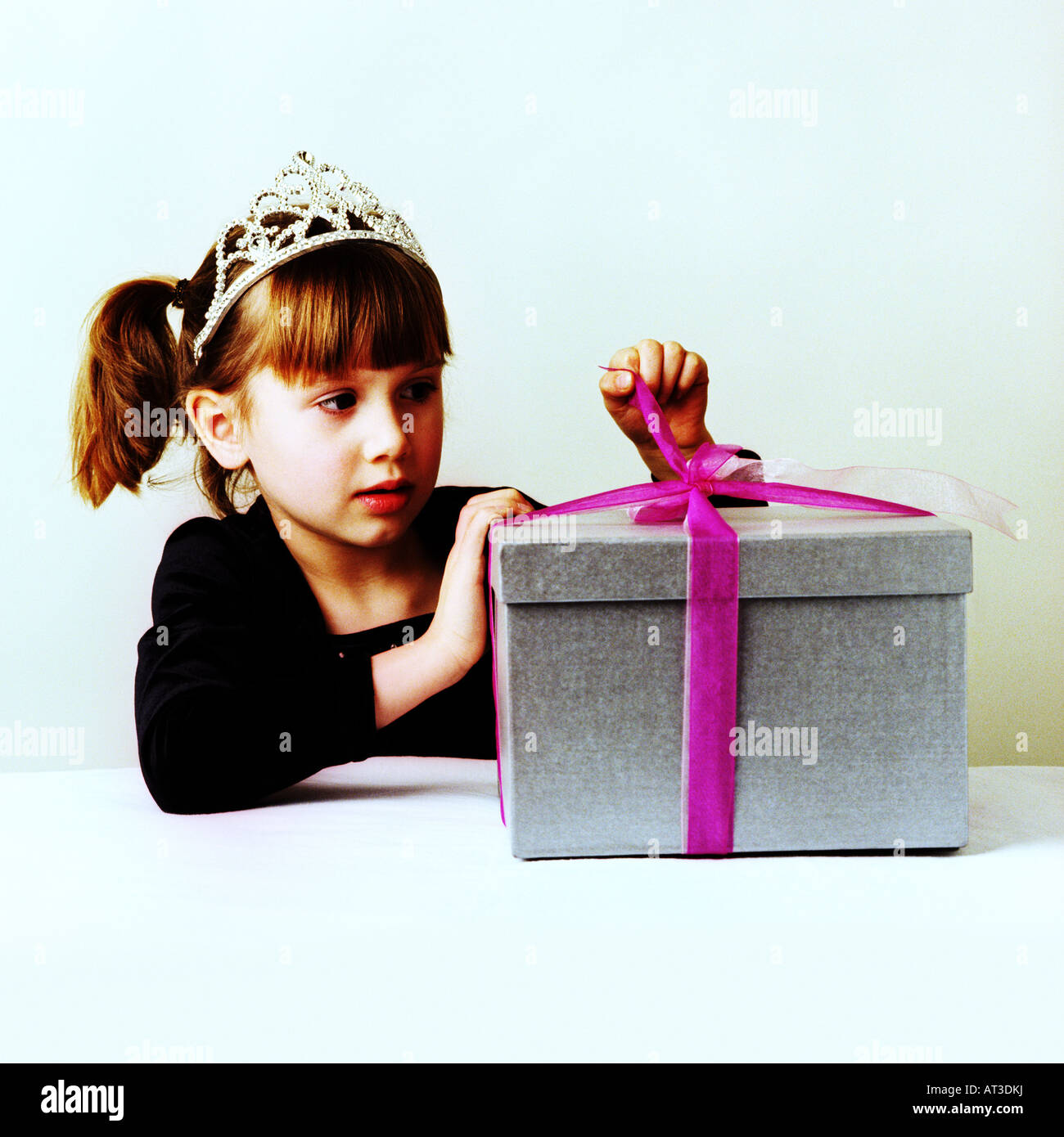 A girl opening a present Stock Photo - Alamy