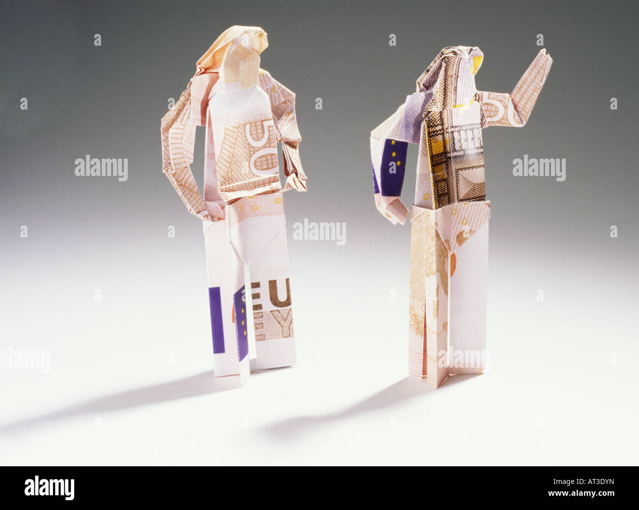 Two origami men made from euro notes Stock Photo - Alamy