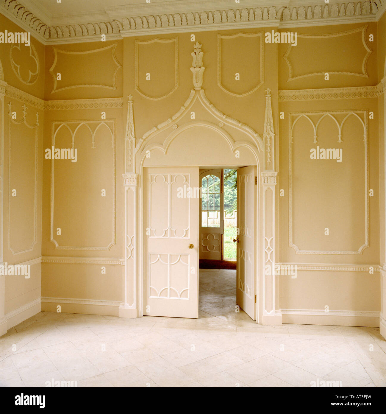 Ornate plasterwork on walls and cornice in empty Gothic room with ...