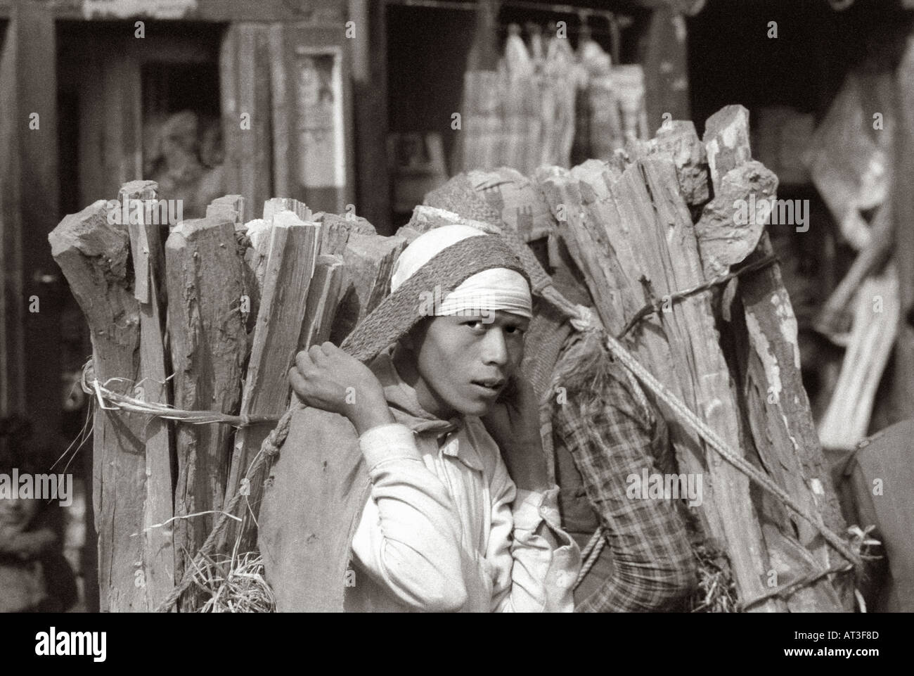 Young man carrying heavy load of wood Kathmandu Nepal Stock Photo - Alamy