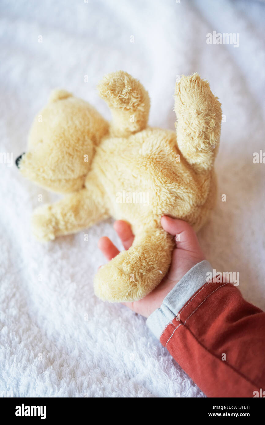 A baby holding a teddy bear, close-up of hand Stock Photo - Alamy