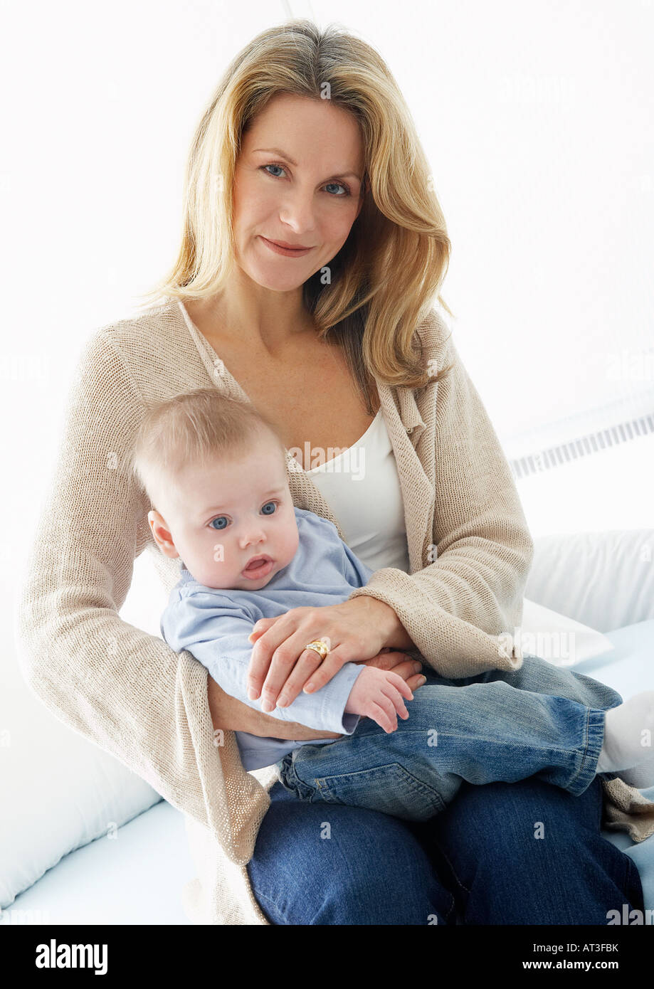Mother seated with baby on her knee Stock Photo - Alamy