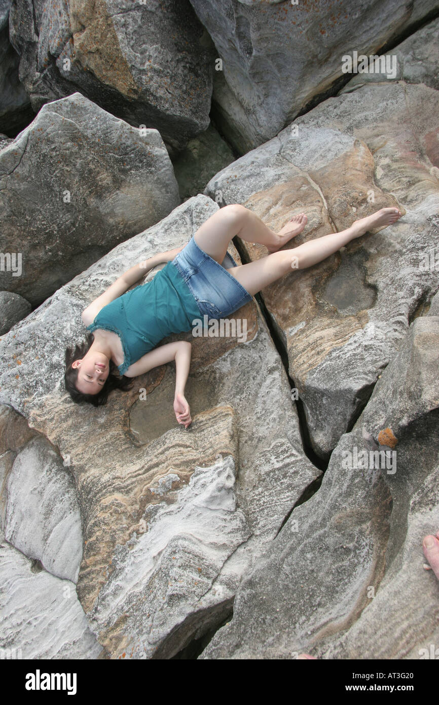 Girl lying on rocks hi-res stock photography and images - Alamy