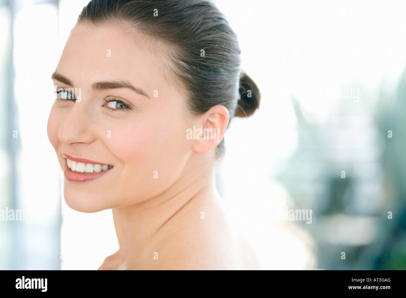 Portrait of young woman, turning head to camera Stock Photo - Alamy