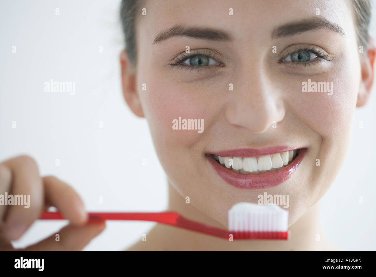 Woman holding toothbrush with toothpaste, brushing her teeth Stock ...
