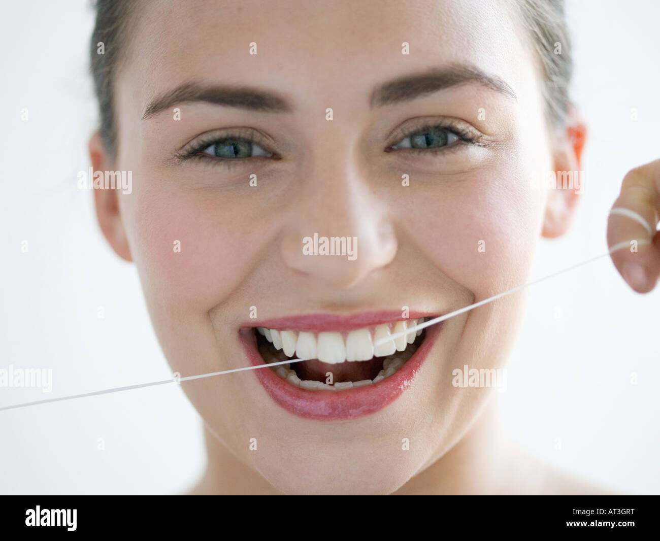 Woman flossing her teeth Stock Photo - Alamy