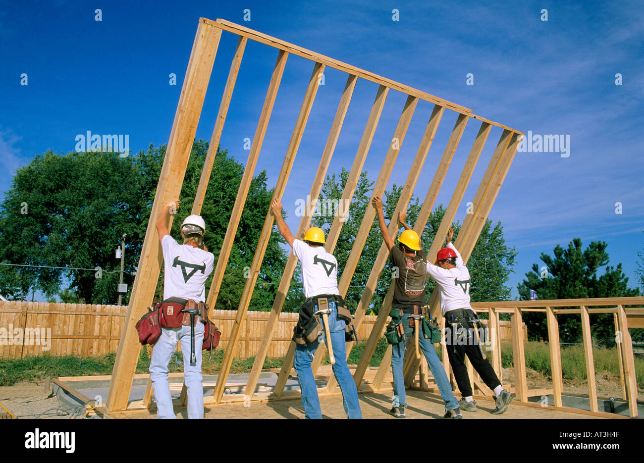 Construction workers lifting a stud wall into place Stock Photo - Alamy