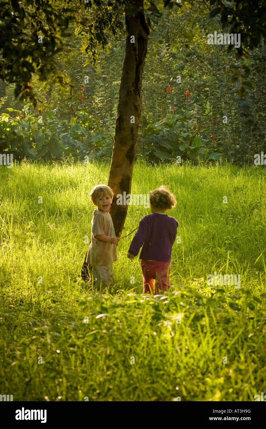 children playing in grassy field Stock Photo - Alamy