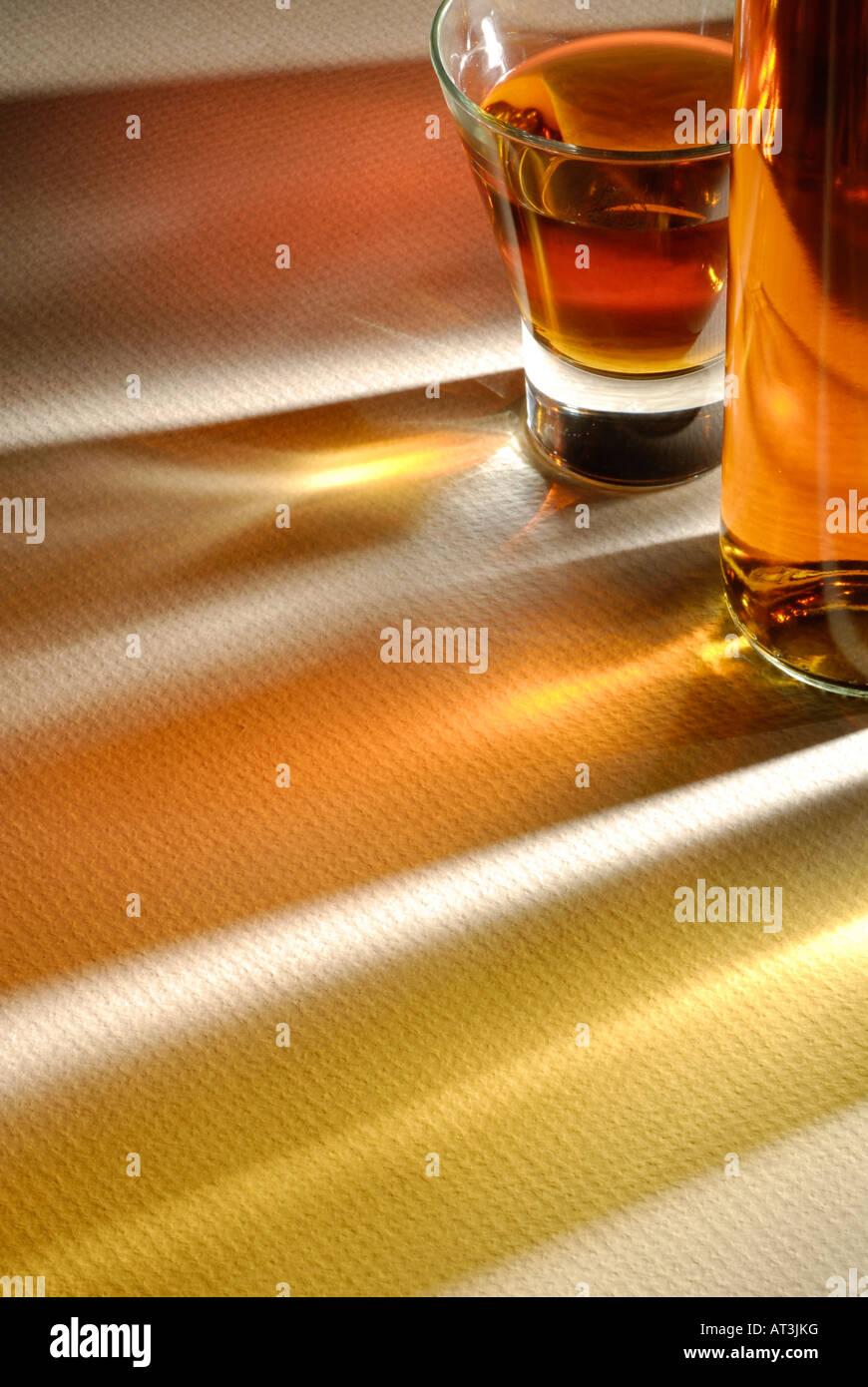 Rum Bottle and glass with shadows Stock Photo - Alamy