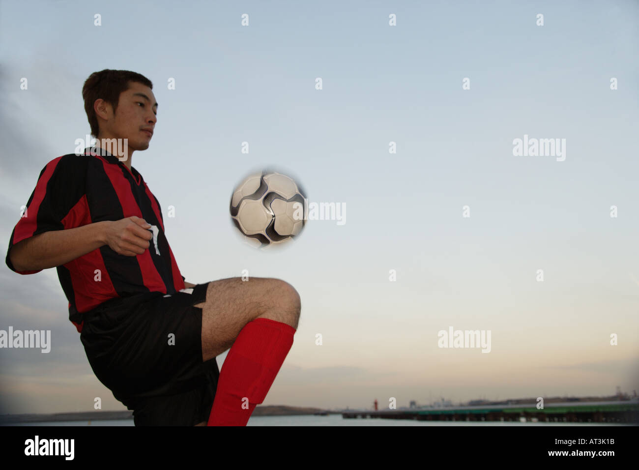 Soccer player juggling ball Stock Photo - Alamy