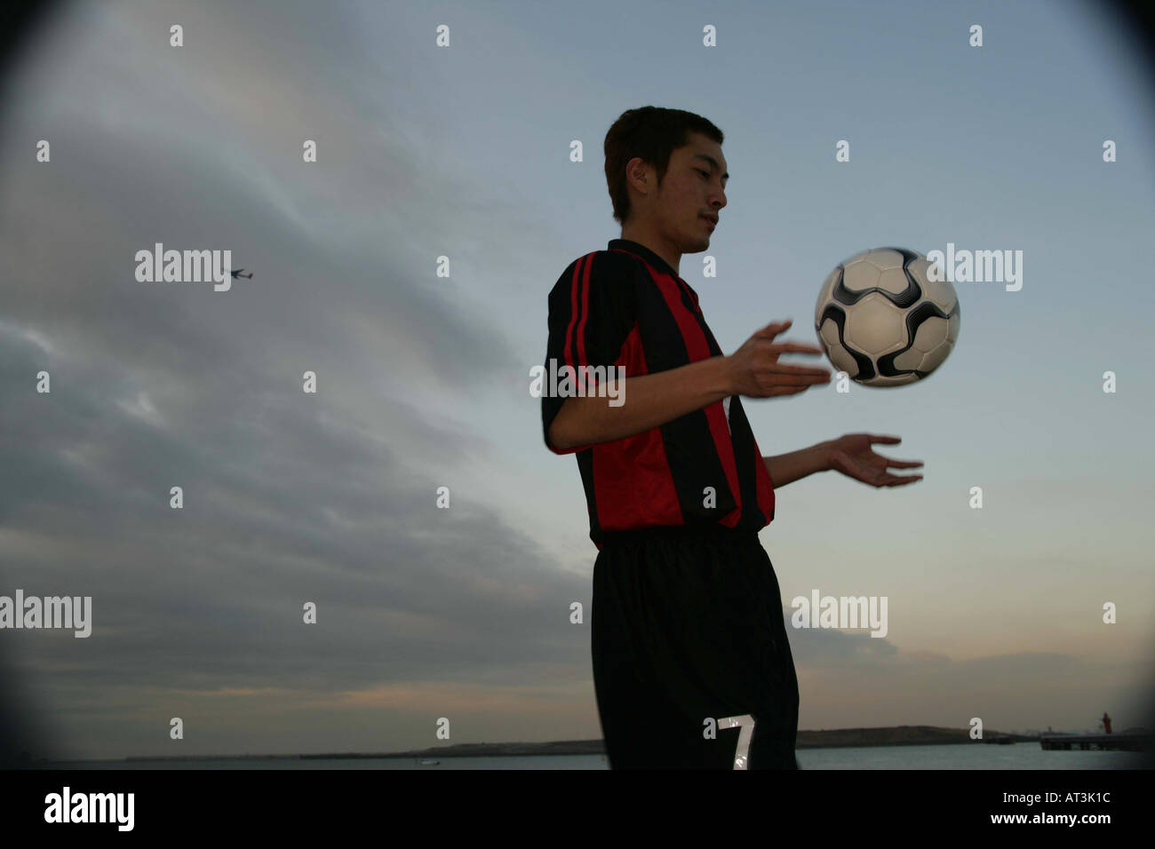 Soccer player juggling ball Stock Photo - Alamy