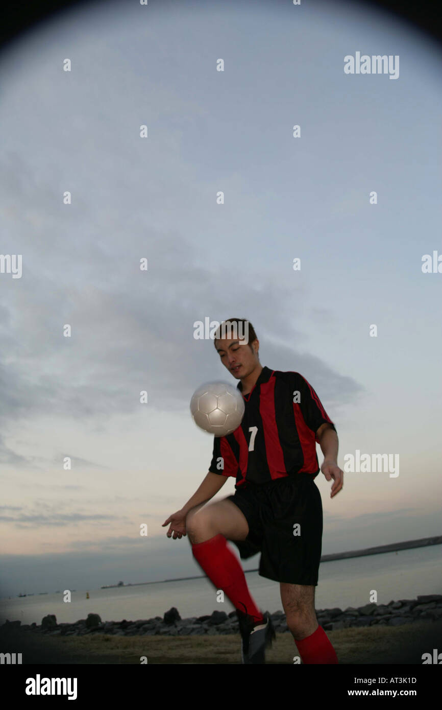Soccer player juggling ball Stock Photo - Alamy