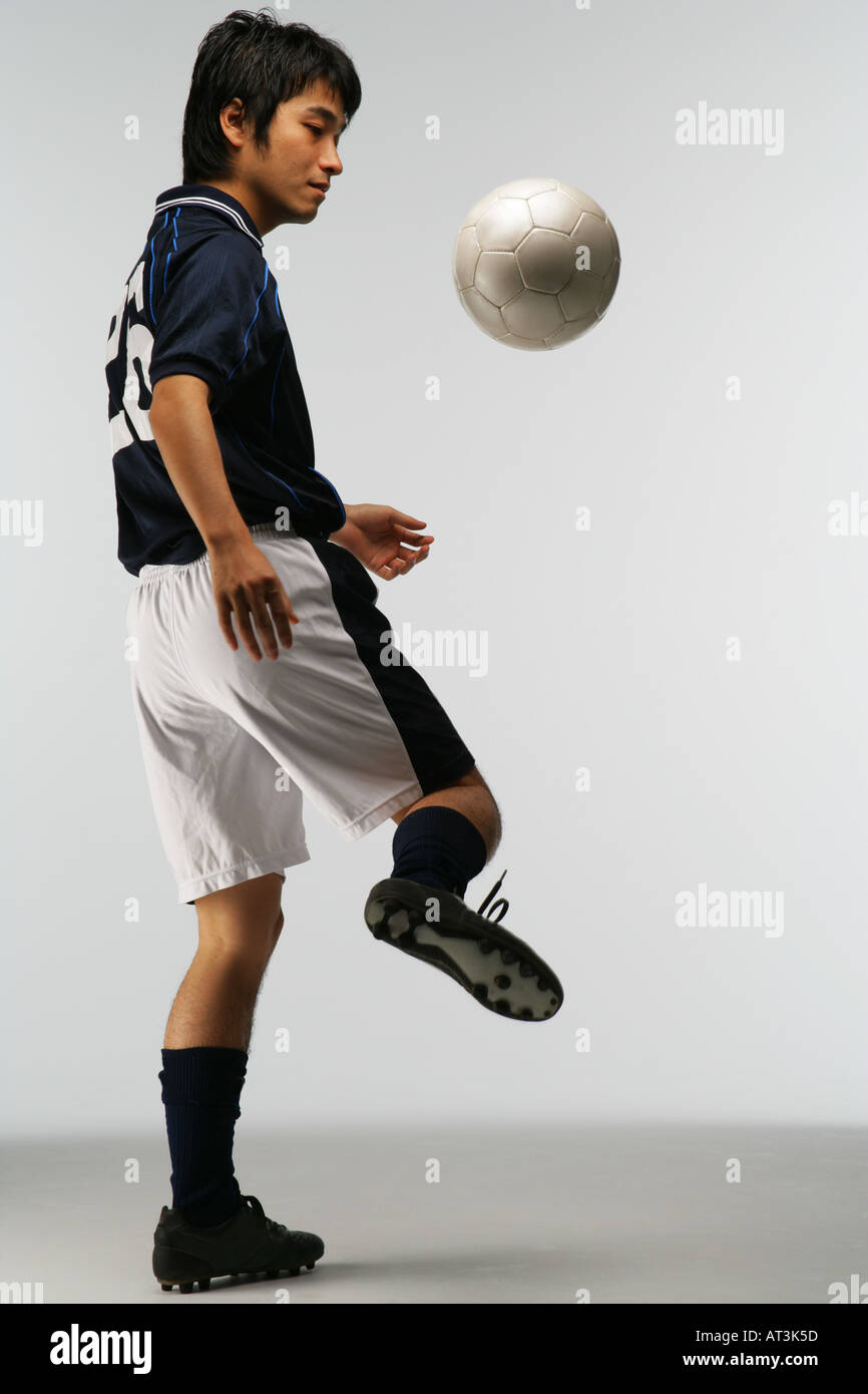 Soccer player juggling ball Stock Photo - Alamy