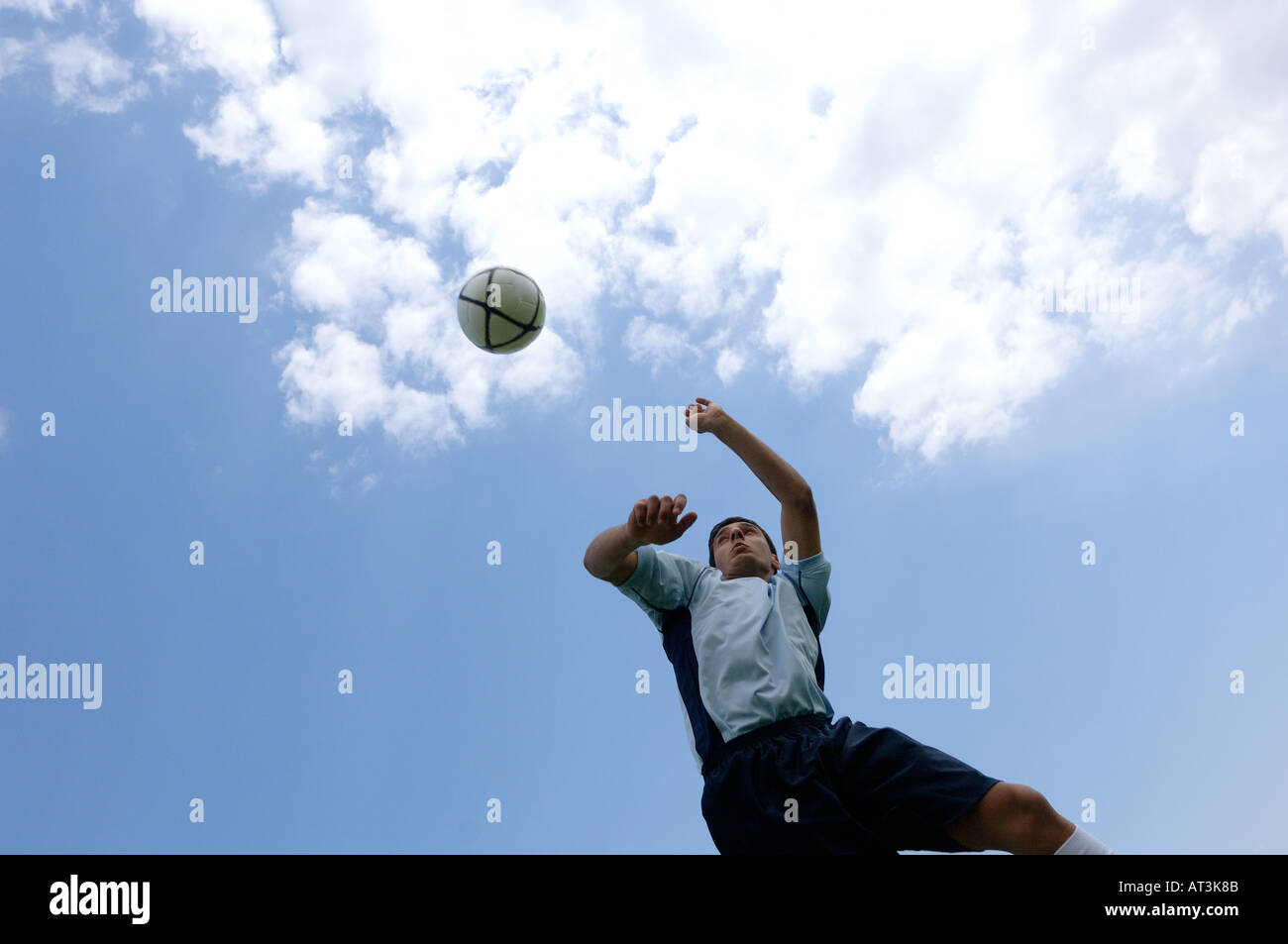 Soccer player heading ball Stock Photo - Alamy