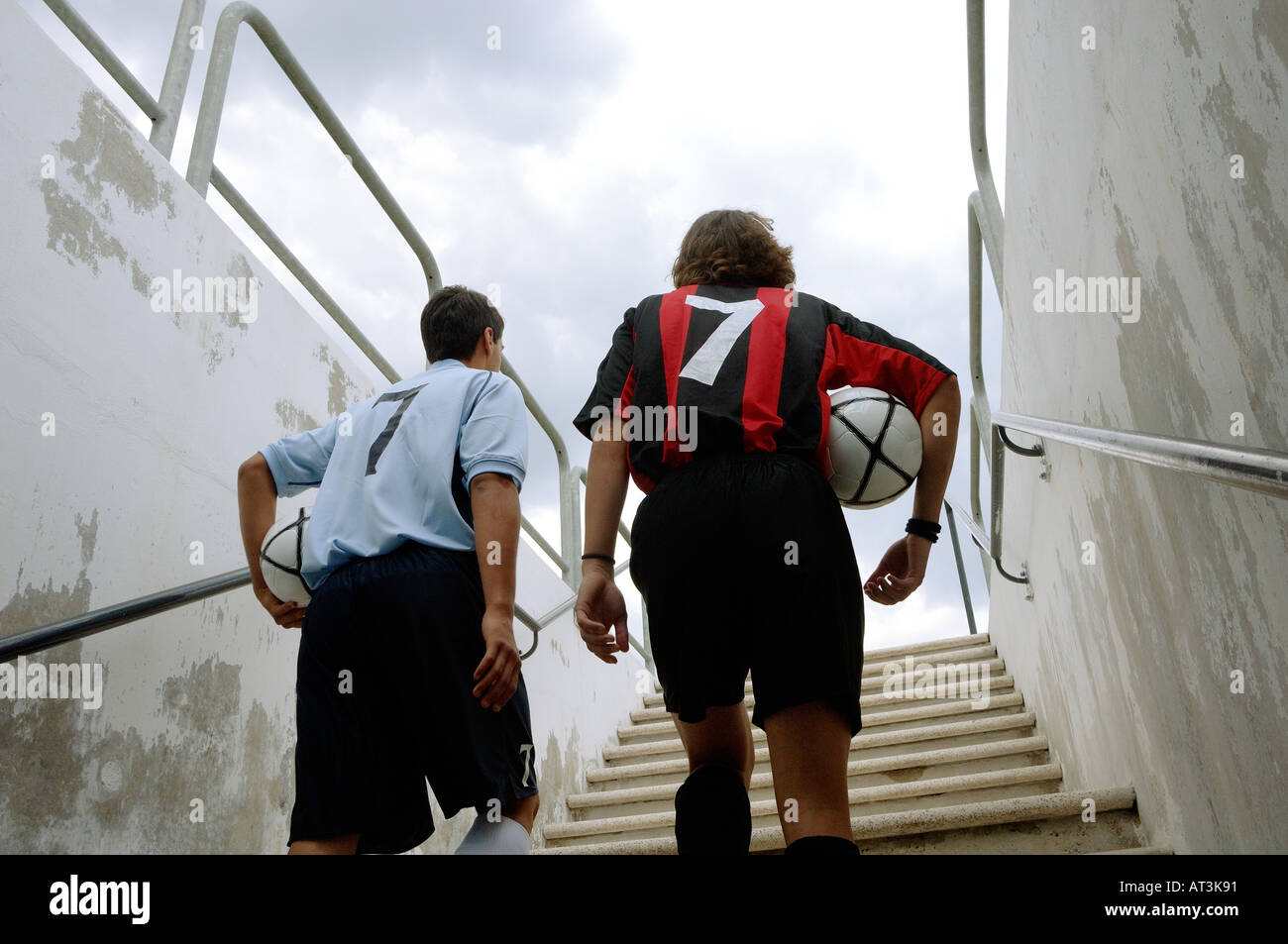 Opponents climbing steps into stadium Stock Photo - Alamy