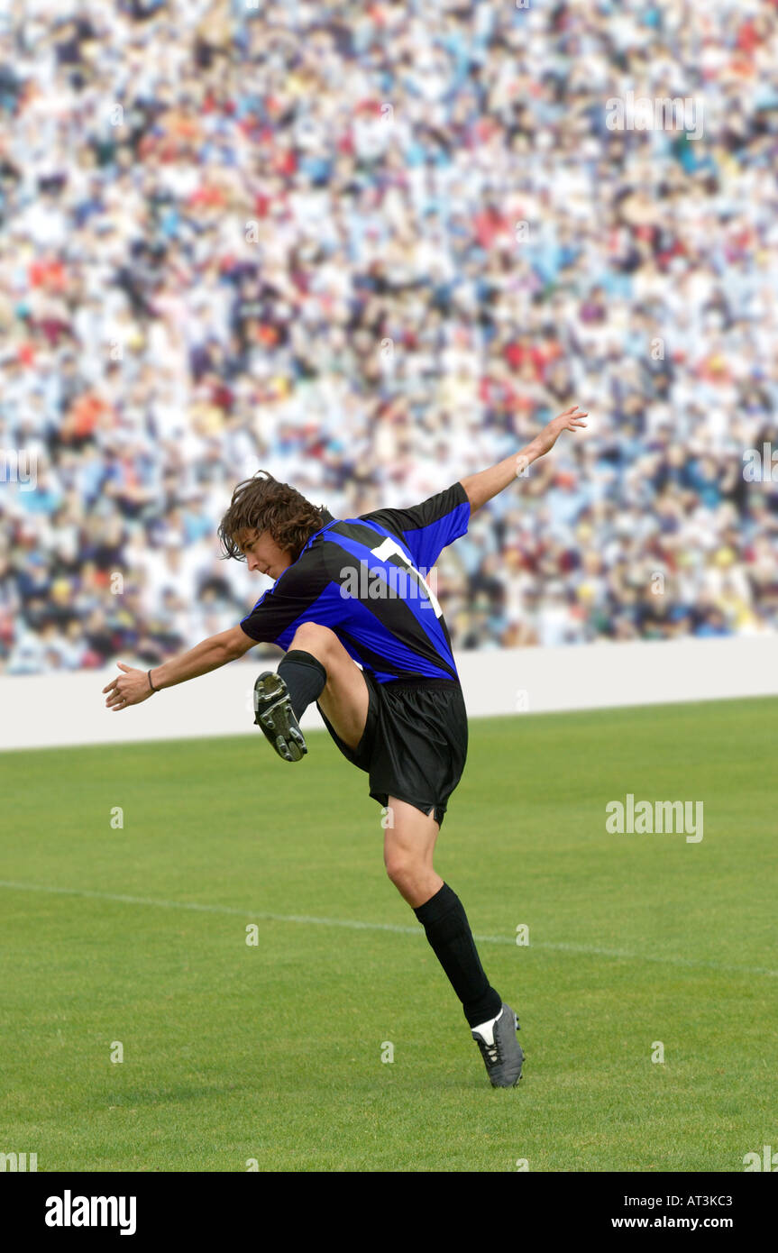 Soccer player striking ball Stock Photo - Alamy