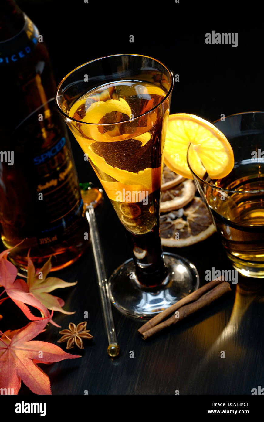 Spiced rum in tall glass with spices Stock Photo - Alamy