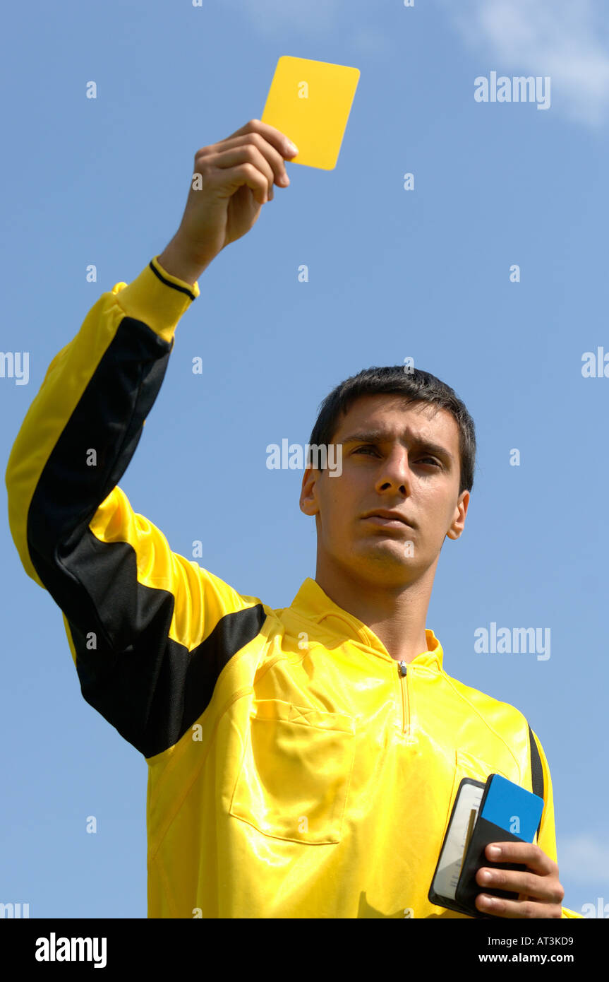 Referee showing yellow card Stock Photo - Alamy