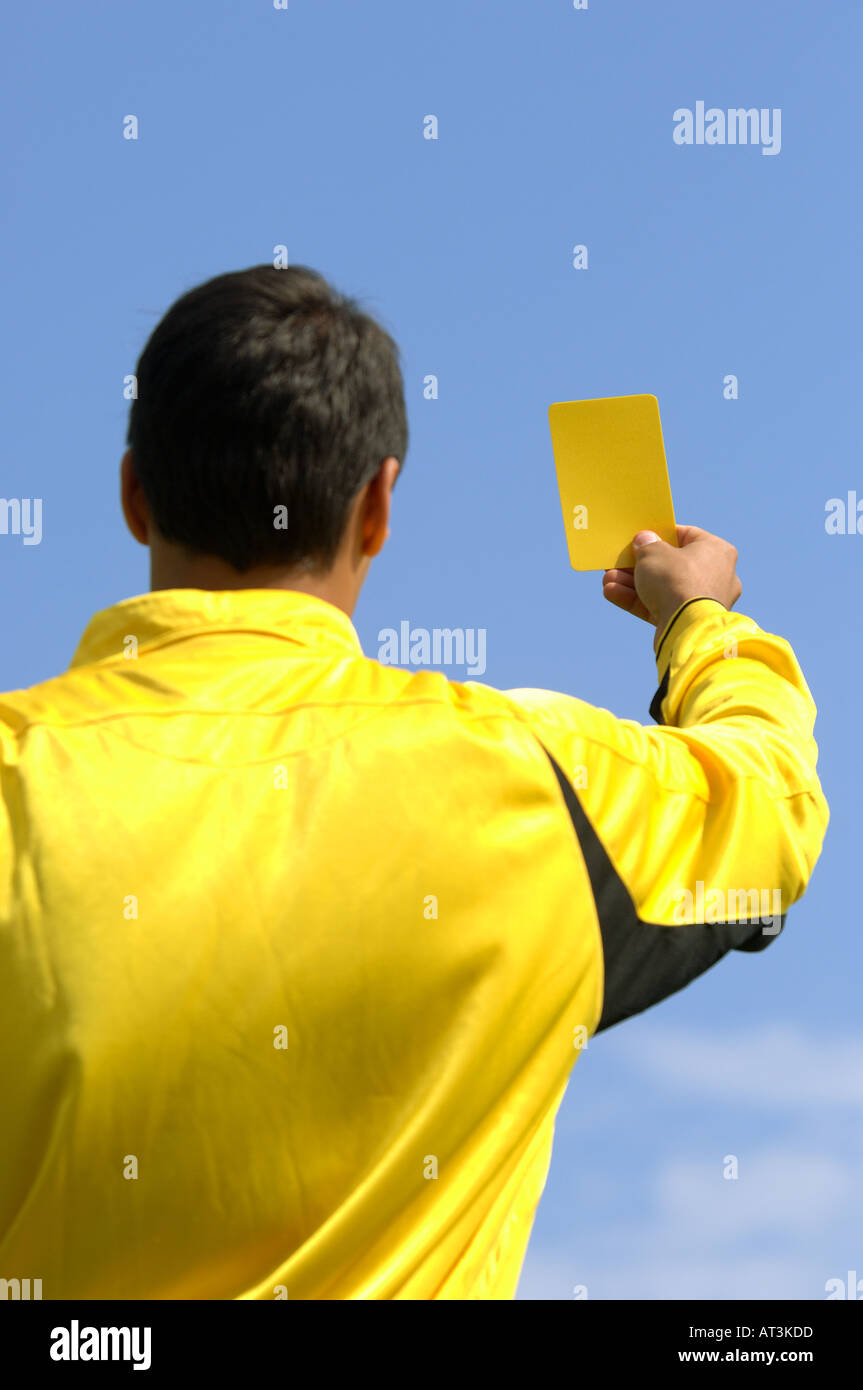 Referee showing yellow card Stock Photo - Alamy