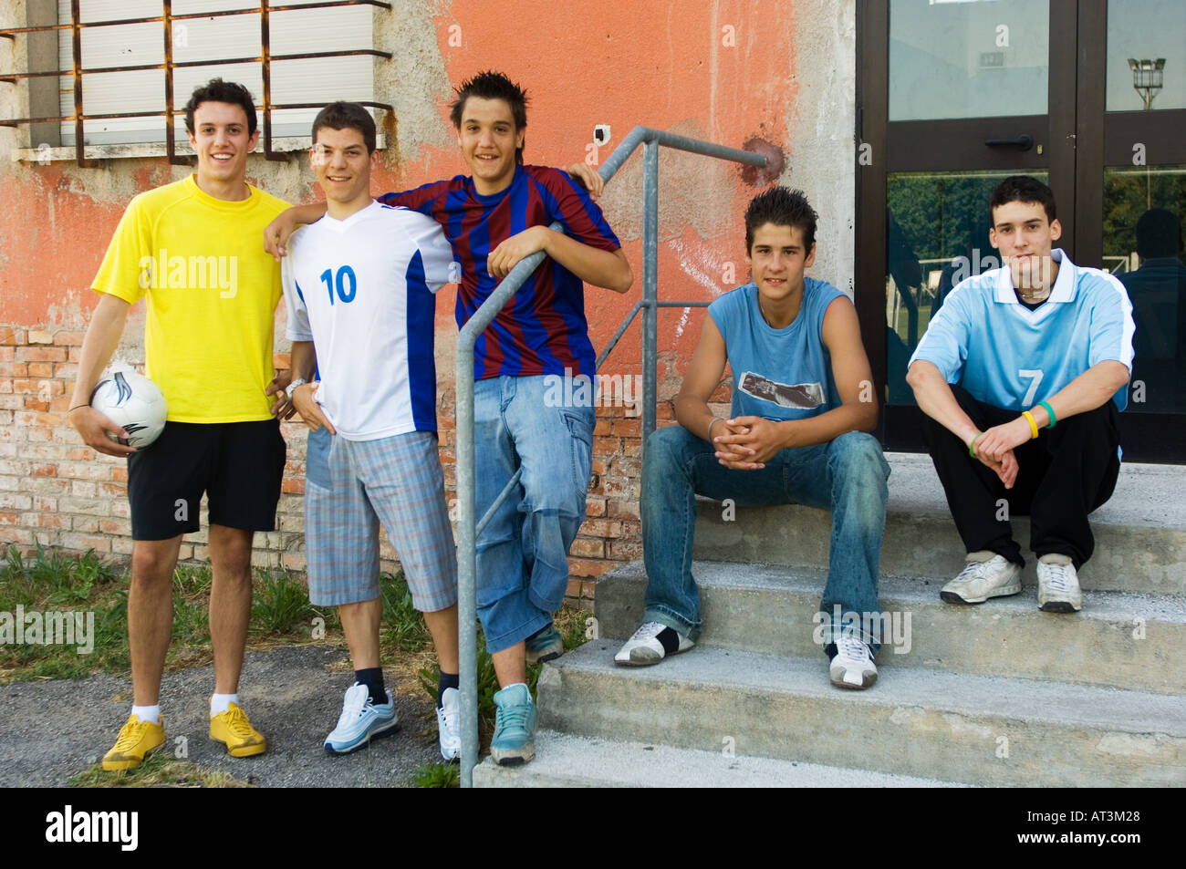 Group of teenage soccer friends on steps Stock Photo - Alamy
