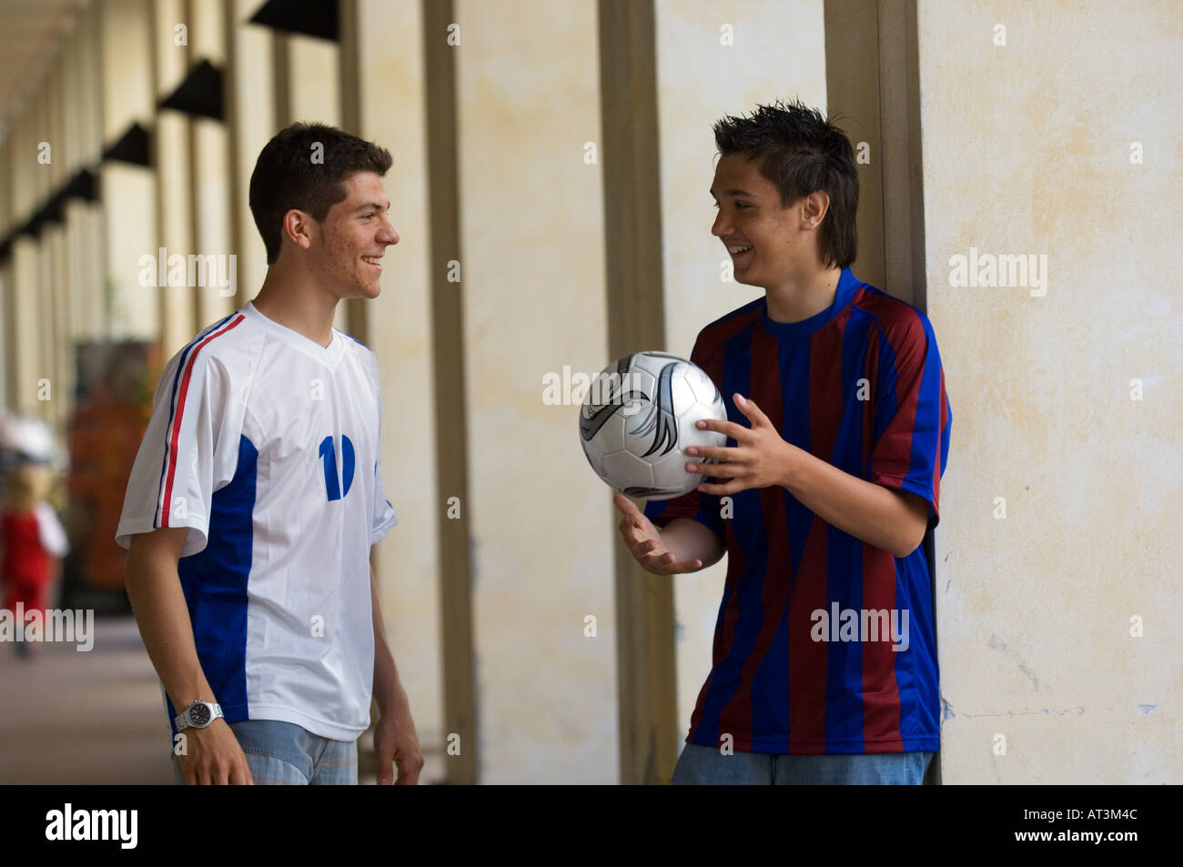 Teenage boys chatting in town Stock Photo - Alamy