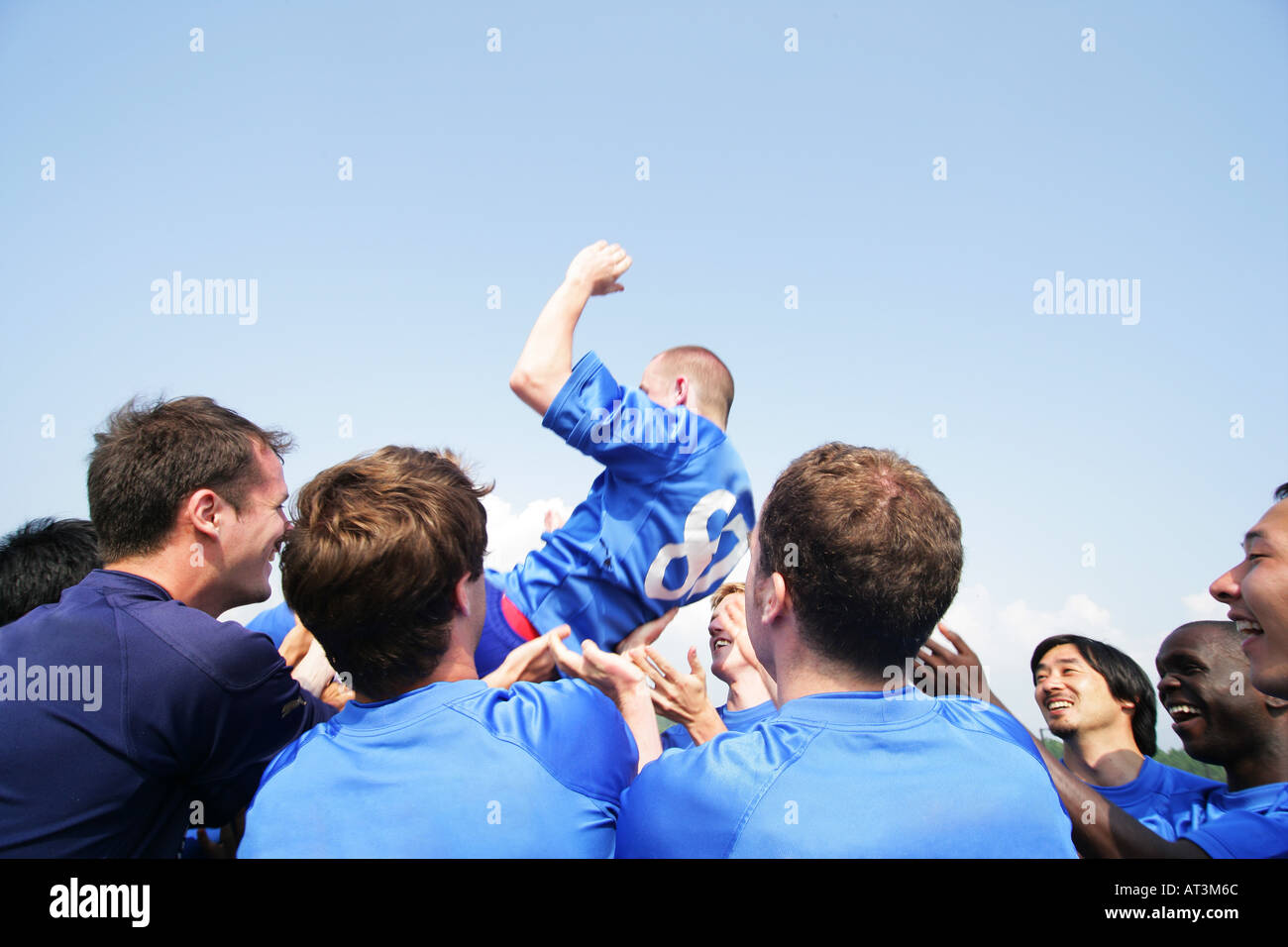 Soccer team celebrating Stock Photo - Alamy