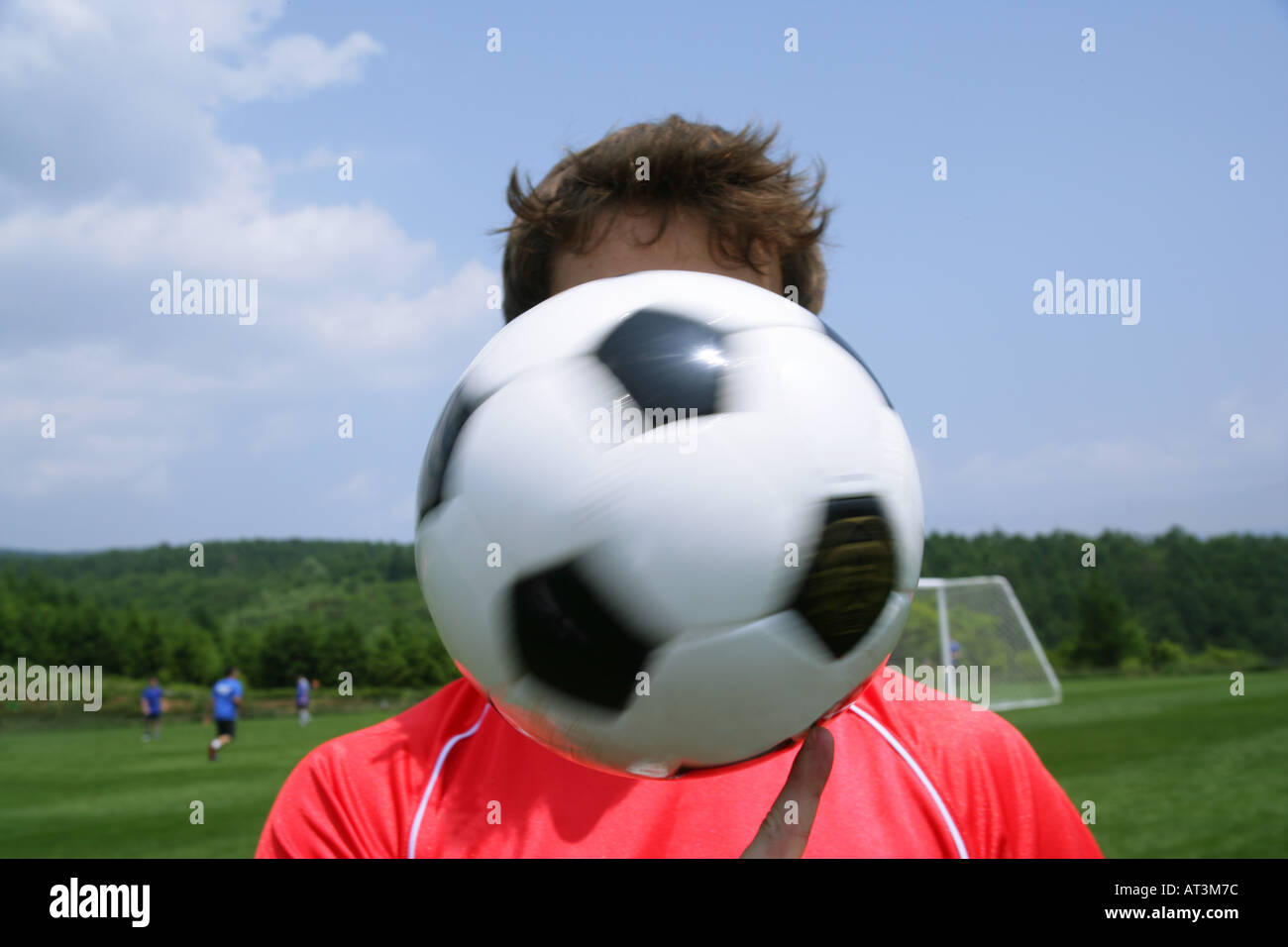 Soccer player s face obscured by ball Stock Photo - Alamy