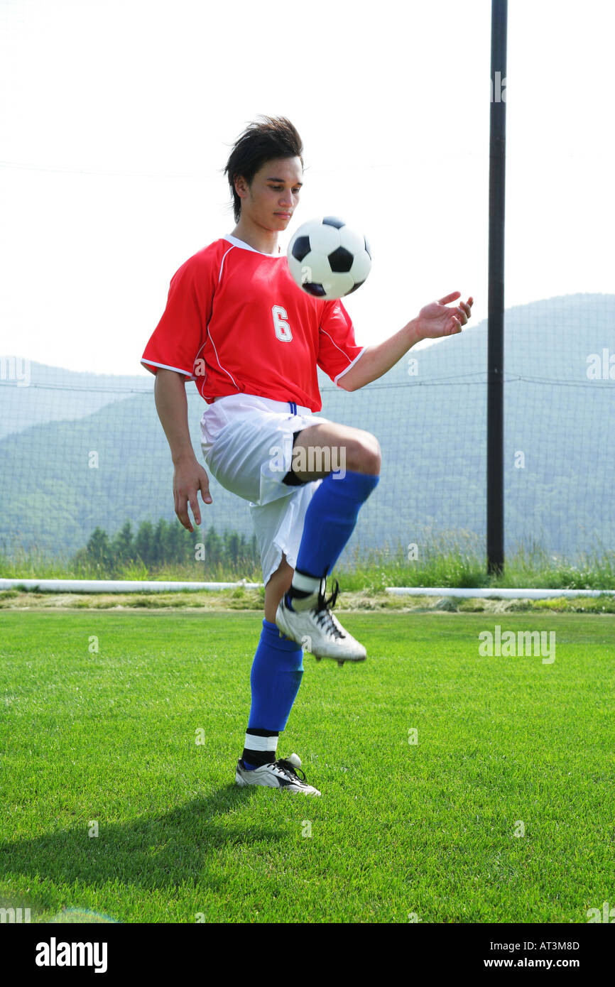 Soccer player juggling ball Stock Photo - Alamy