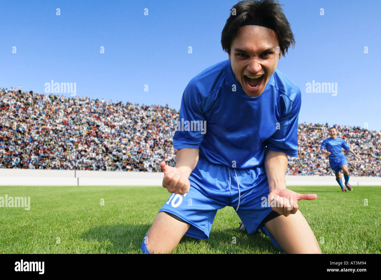 Soccer player celebrating Stock Photo - Alamy