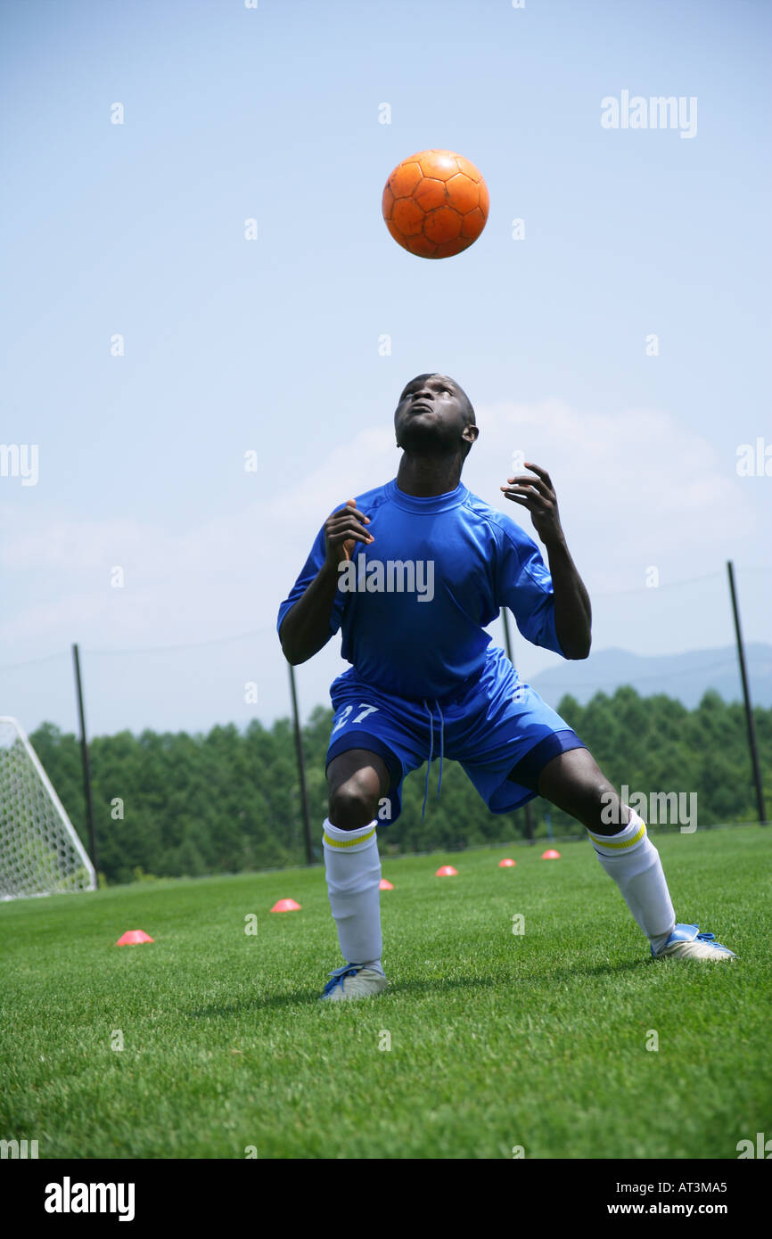 Soccer player juggling ball Stock Photo - Alamy