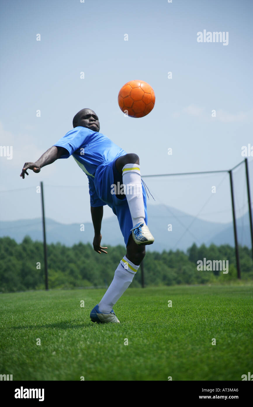Soccer player juggling ball Stock Photo - Alamy